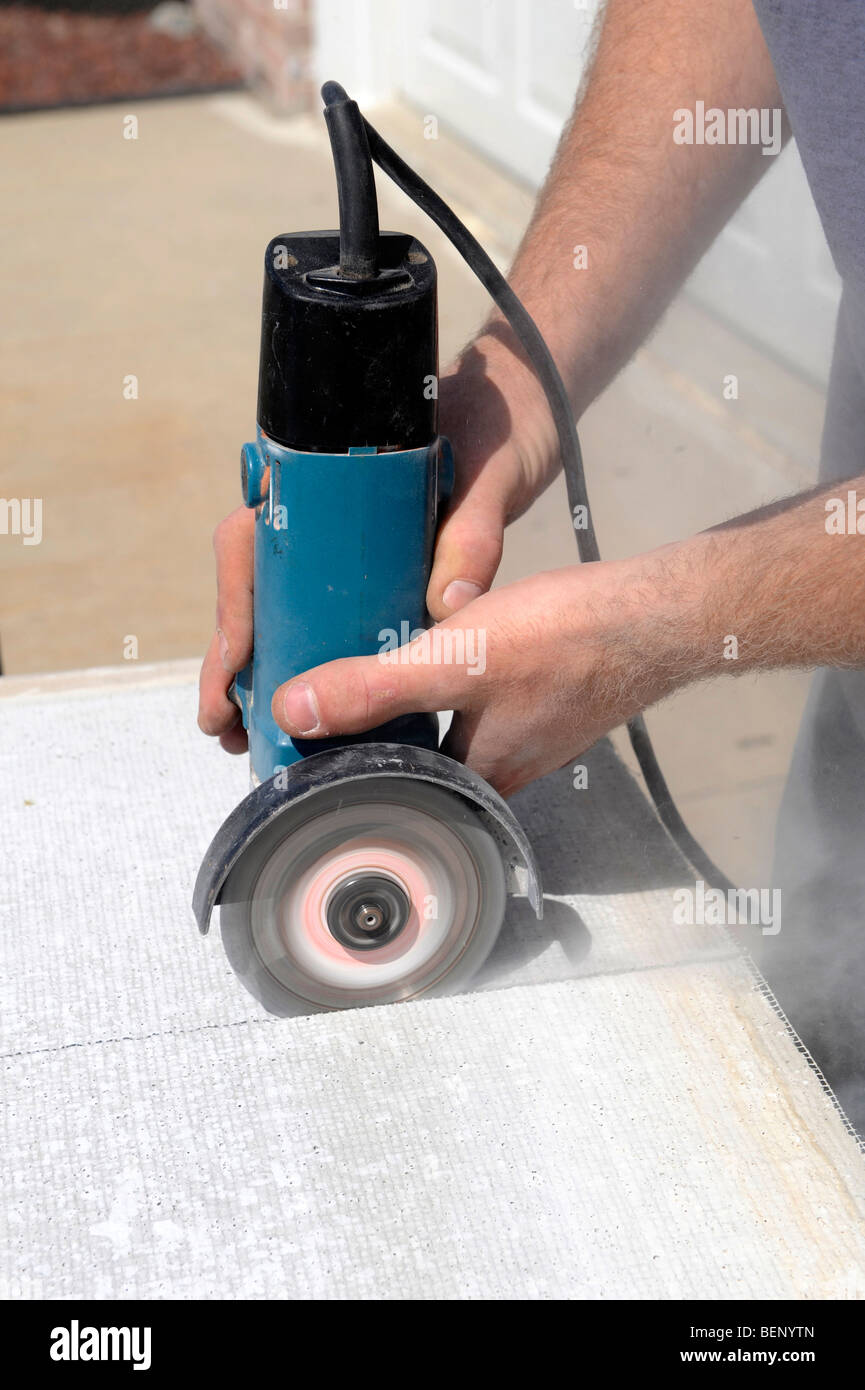 Carpenter using power cutting tool in construction project Stock Photo ...