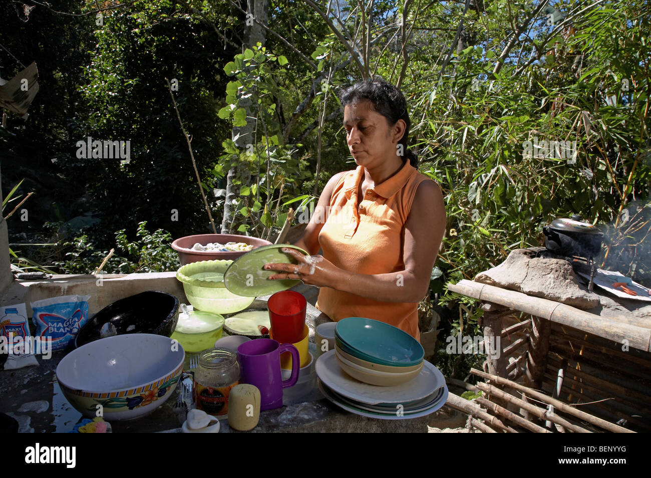 El Salvador Woman with HIV, washing dishes Stock Photo - Alamy
