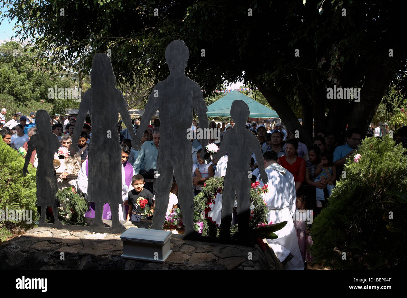 EL SALVADOR El Mozote, site of the massacre of children in 1981. Laying flowers at grave site ...
