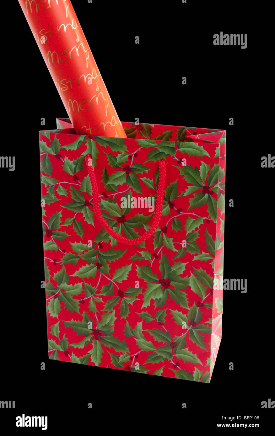 Holly pattern party/ present paper bag with red string handles ...