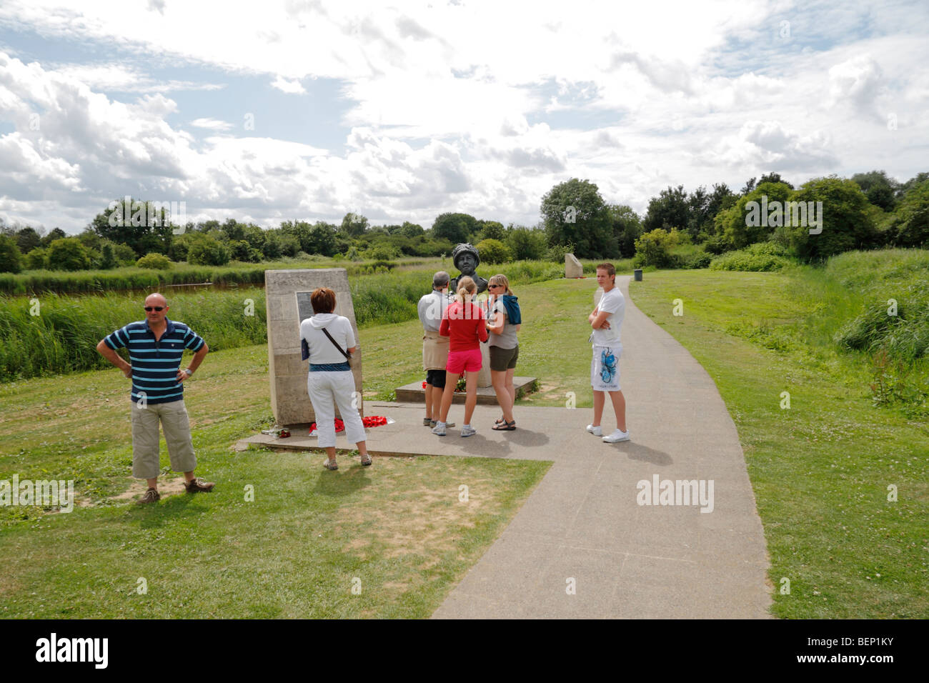 Tourists viewing the memorial to Major John Howard, who led the D-Day ...