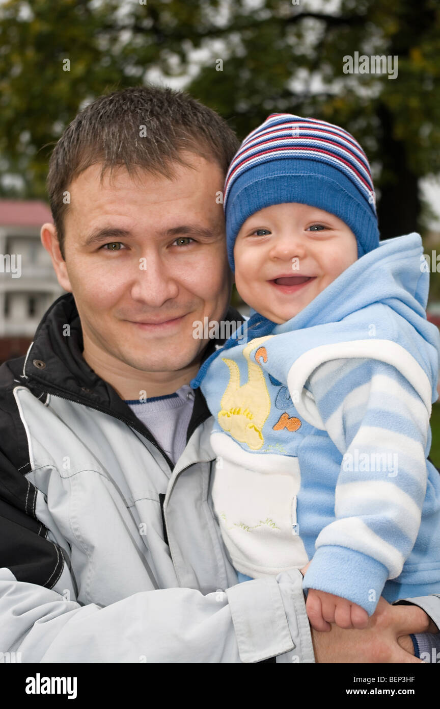 Family portrait: father and his little child on hands Stock Photo - Alamy