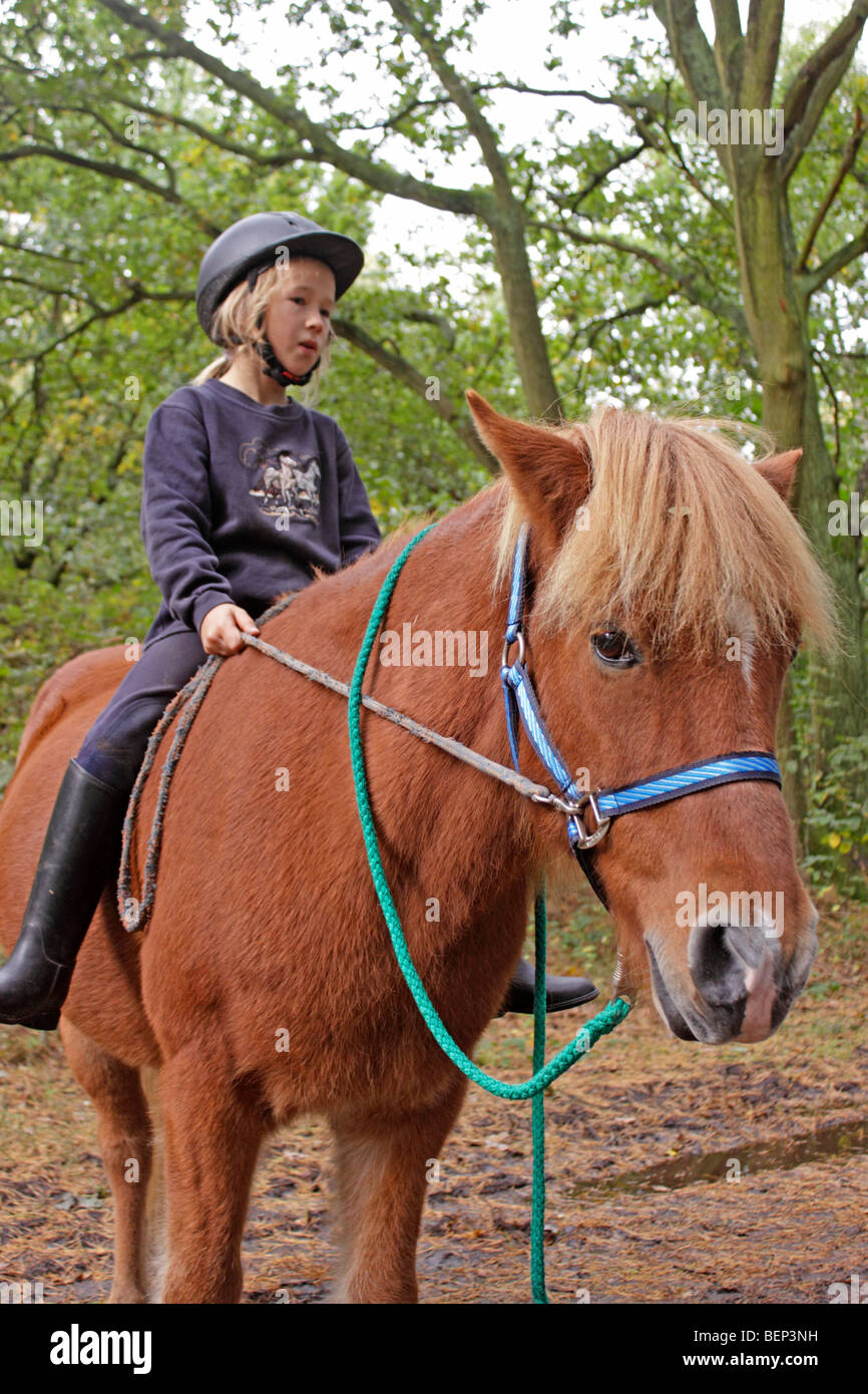 young girl sitting on her pony Stock Photo - Alamy