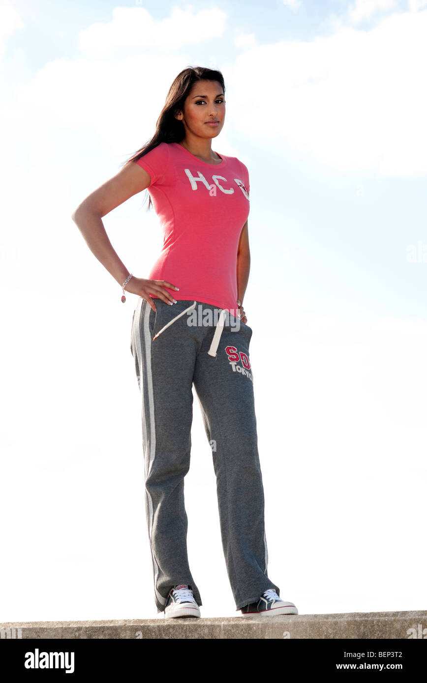woman standing with hands on hips Stock Photo - Alamy