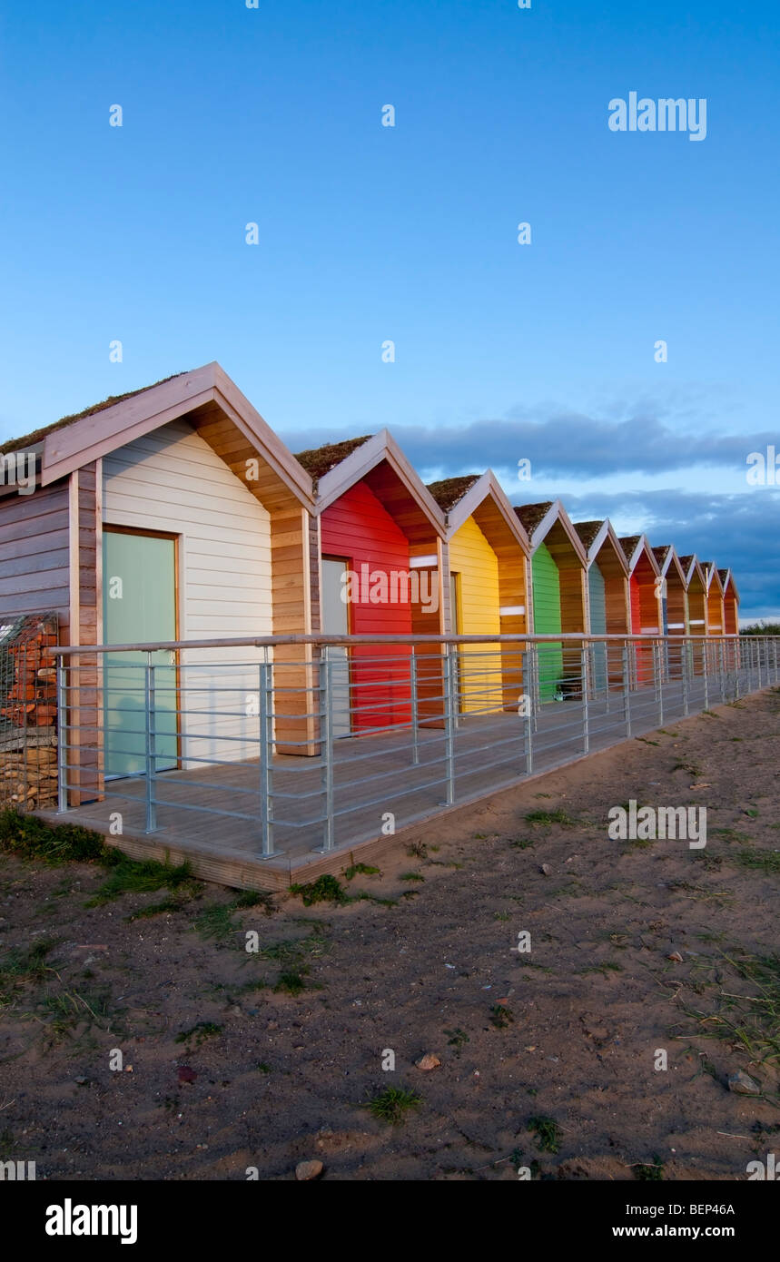 Brightly coloured beach huts at Blyth beach, Northumberland at dusk ...