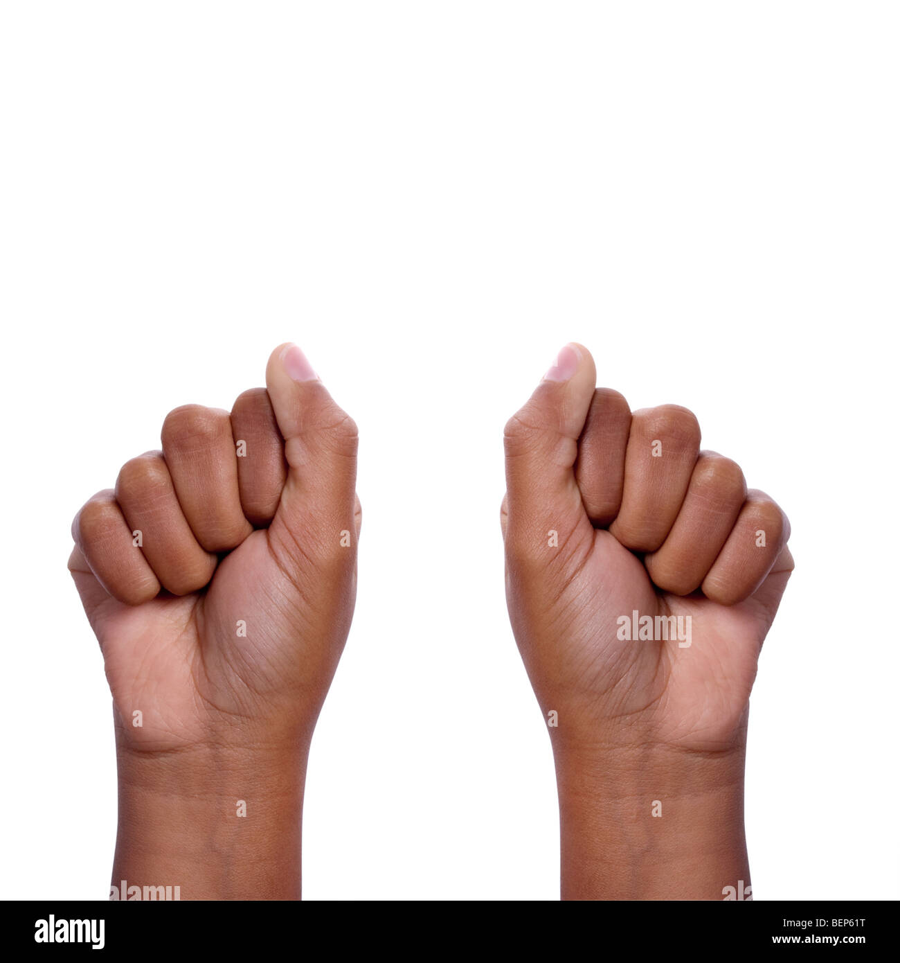 young dark skinned mixed race girls hands making fists as if to hide ...