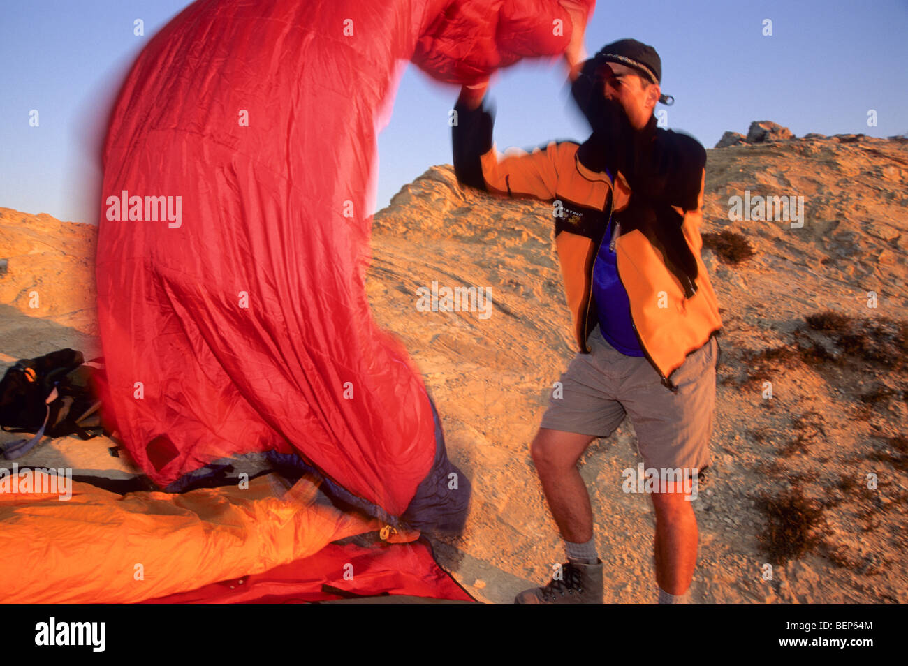 Man fluffing sleeping bag Stock Photo - Alamy