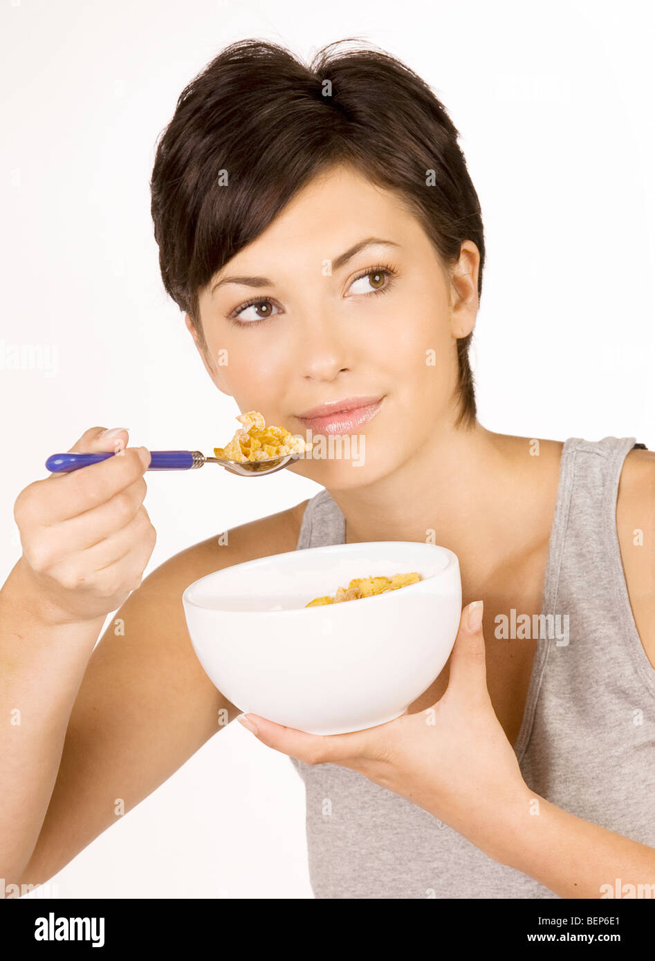 Girl eating from bowl Stock Photo - Alamy