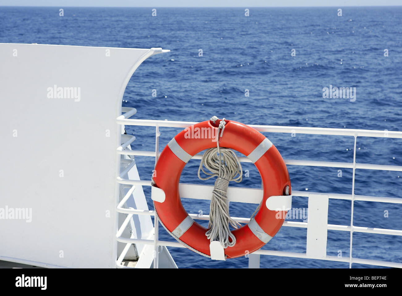 Cruise white boat handrail detail in blue sea and round orange buoy ...