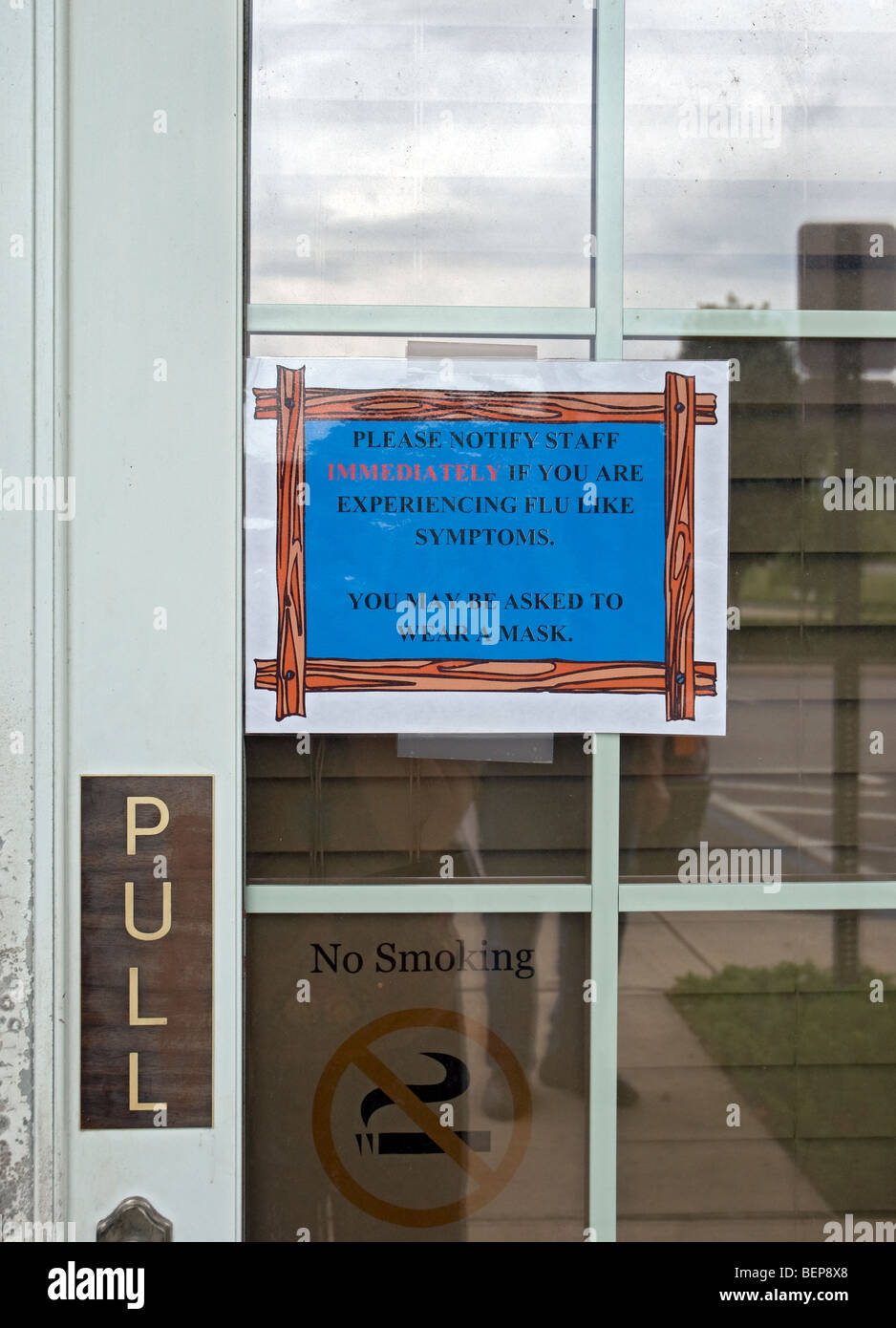 flu warning sign doctor front office door entrance Stock Photo - Alamy