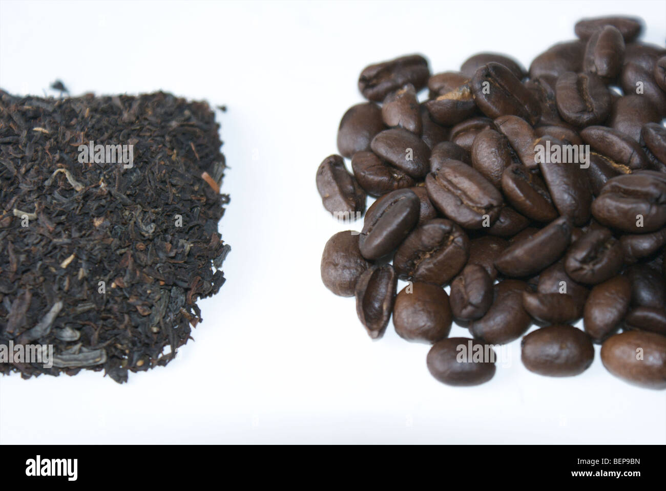 Loose tea and coffee beans side by side, on a white background. The ...