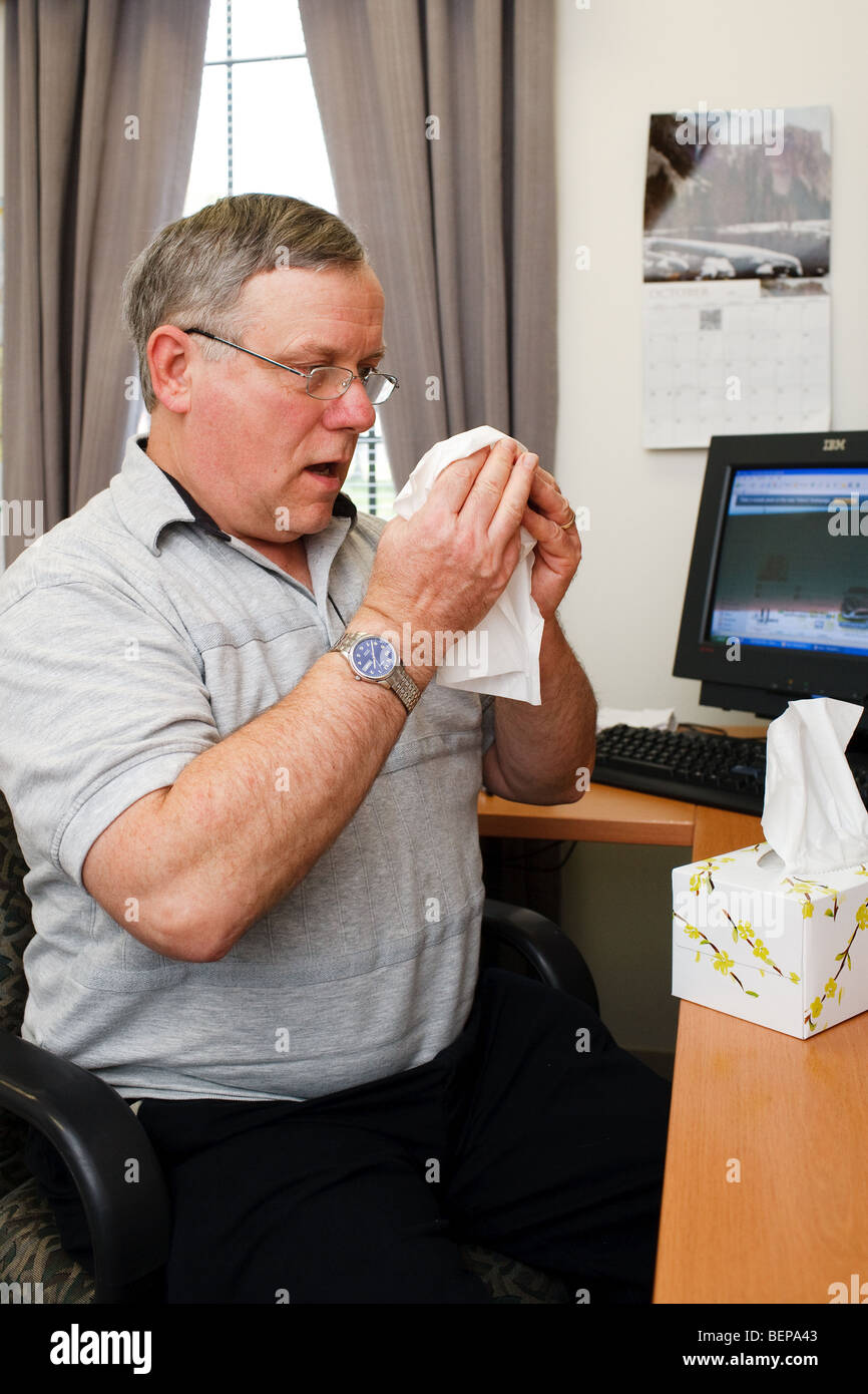 A man sneezing Stock Photo - Alamy