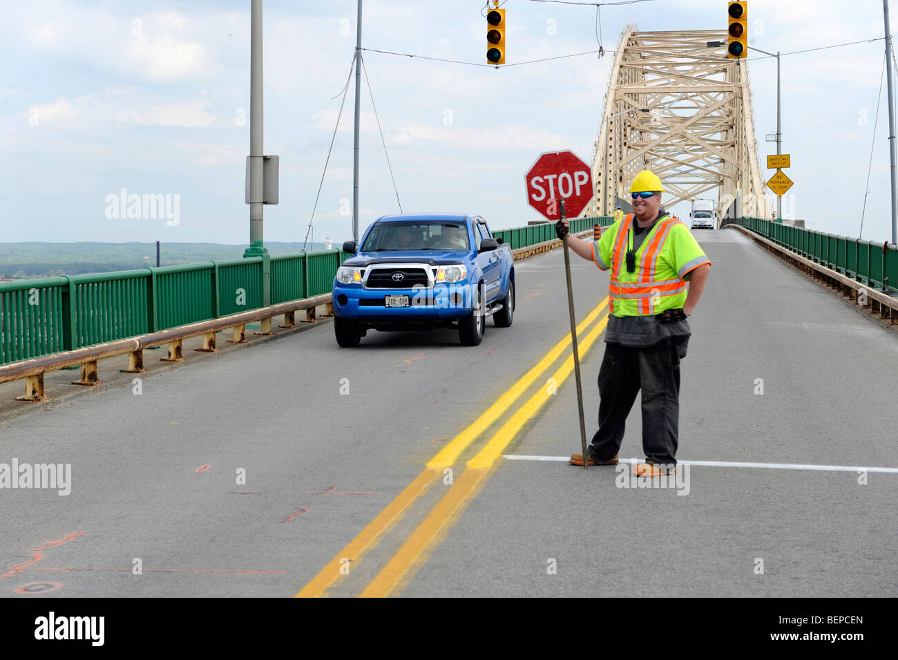 Construction Worker Controls traffic International Bridge connecting ...