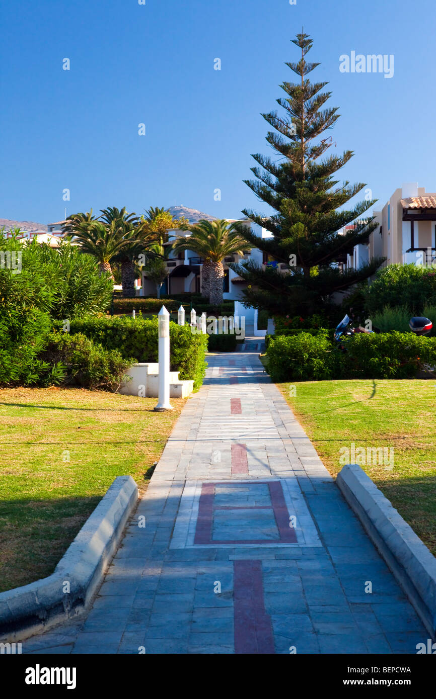 Territory of hotel with a path, palm trees and country houses Stock ...