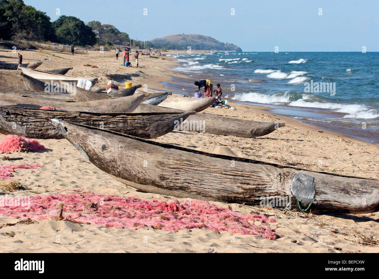 Primitive wooden fishing boats / proas and fishing nets on the beach ...