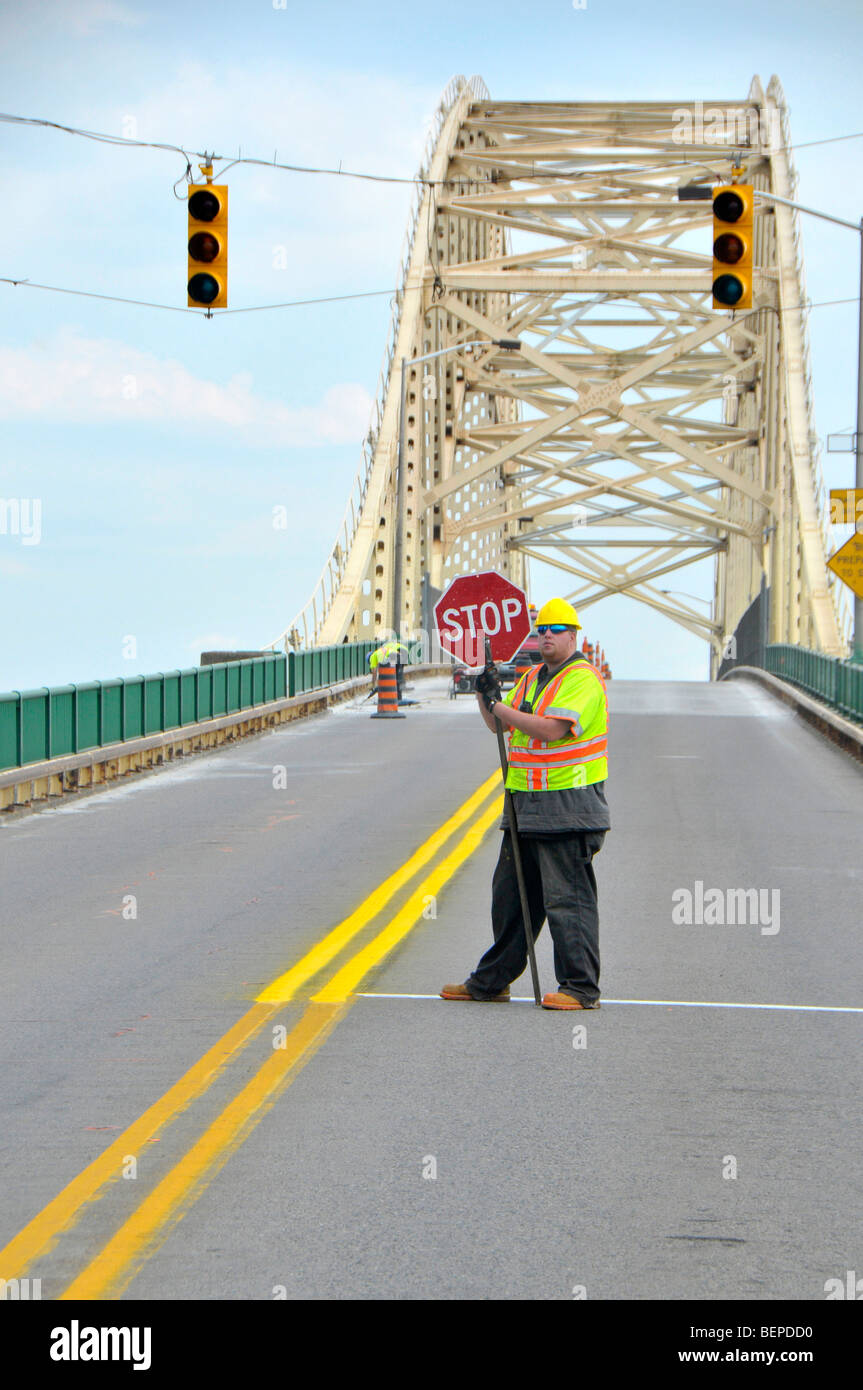 Construction Worker Controls traffic International Bridge connecting ...