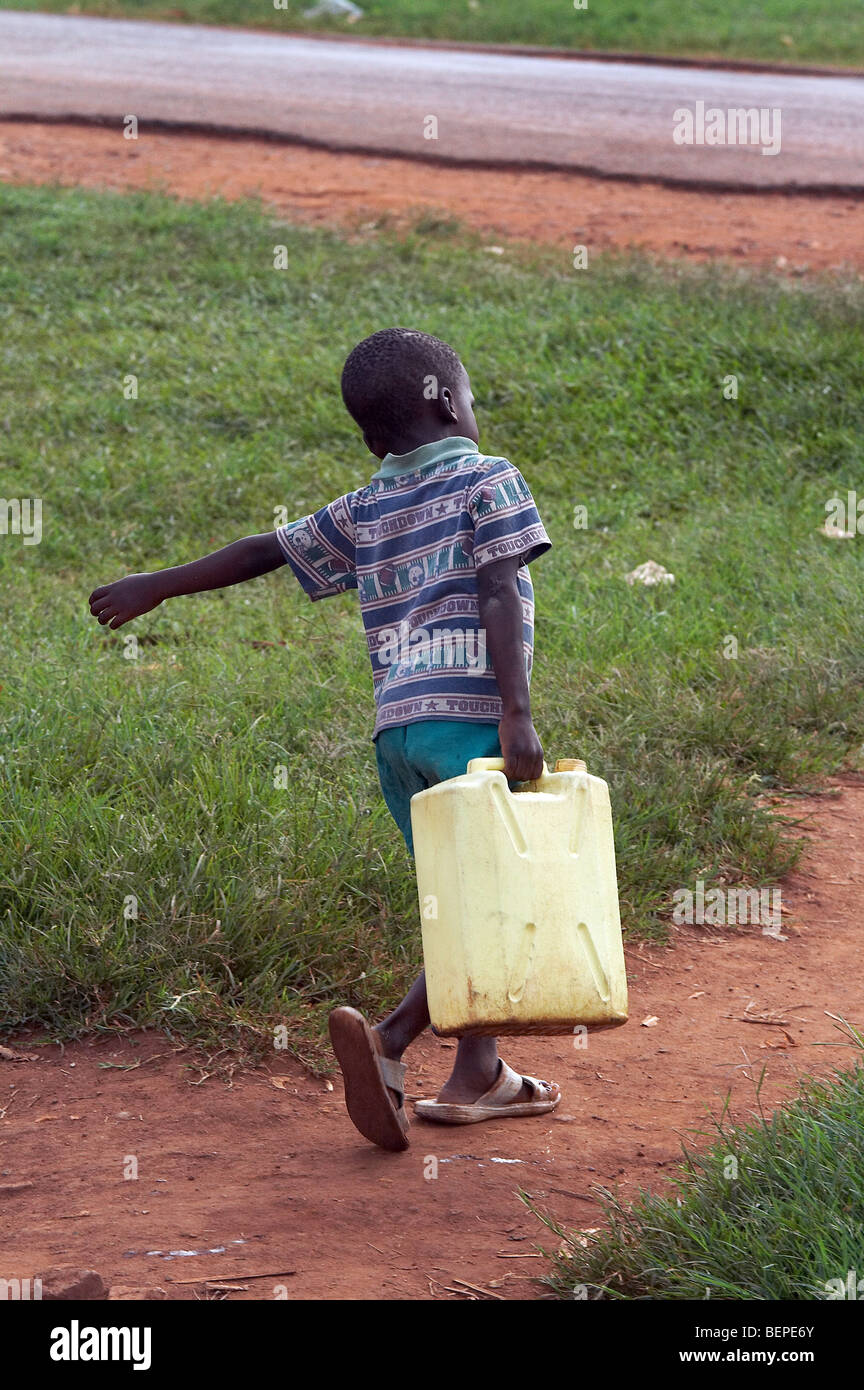UGANDA Boy carrying jerry can, Village of Kabembe, Mukono District ...