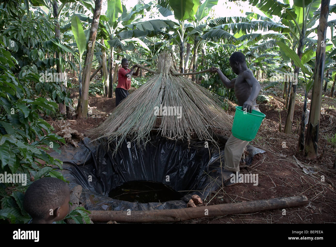 UGANDA Making a water catchment pit Stock Photo - Alamy