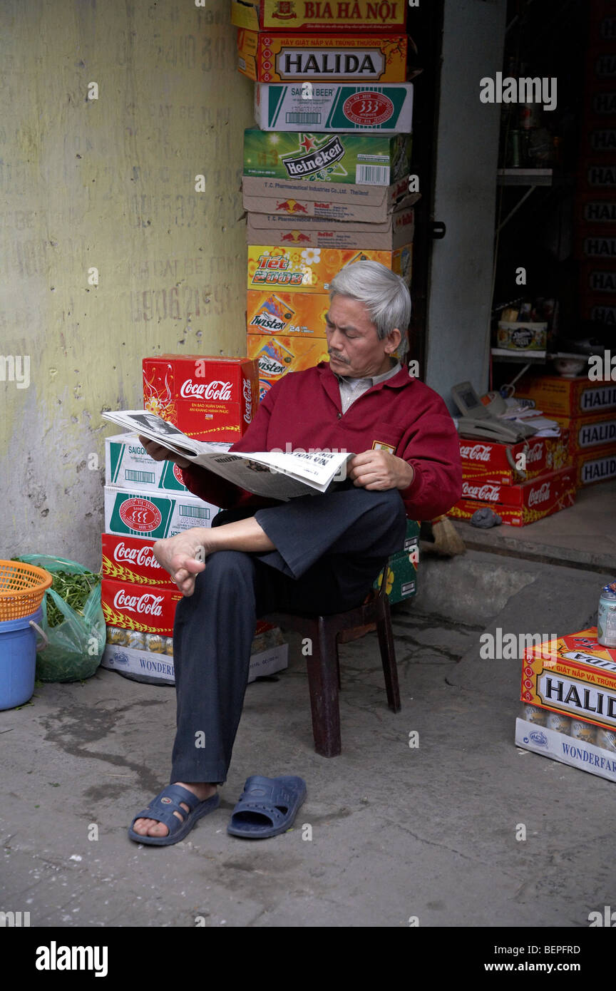 VIETNAM Street scenes, Hanoi. Man reading newspaper. photograph by Sean ...
