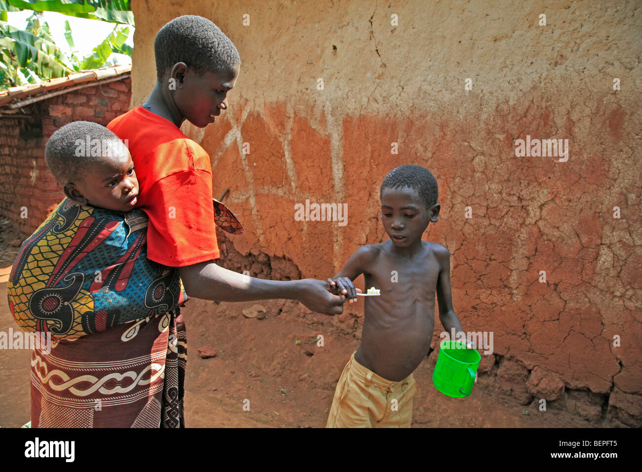 BURUNDI Family of Speciose Ciza (32) and three children, Claude (9 ...