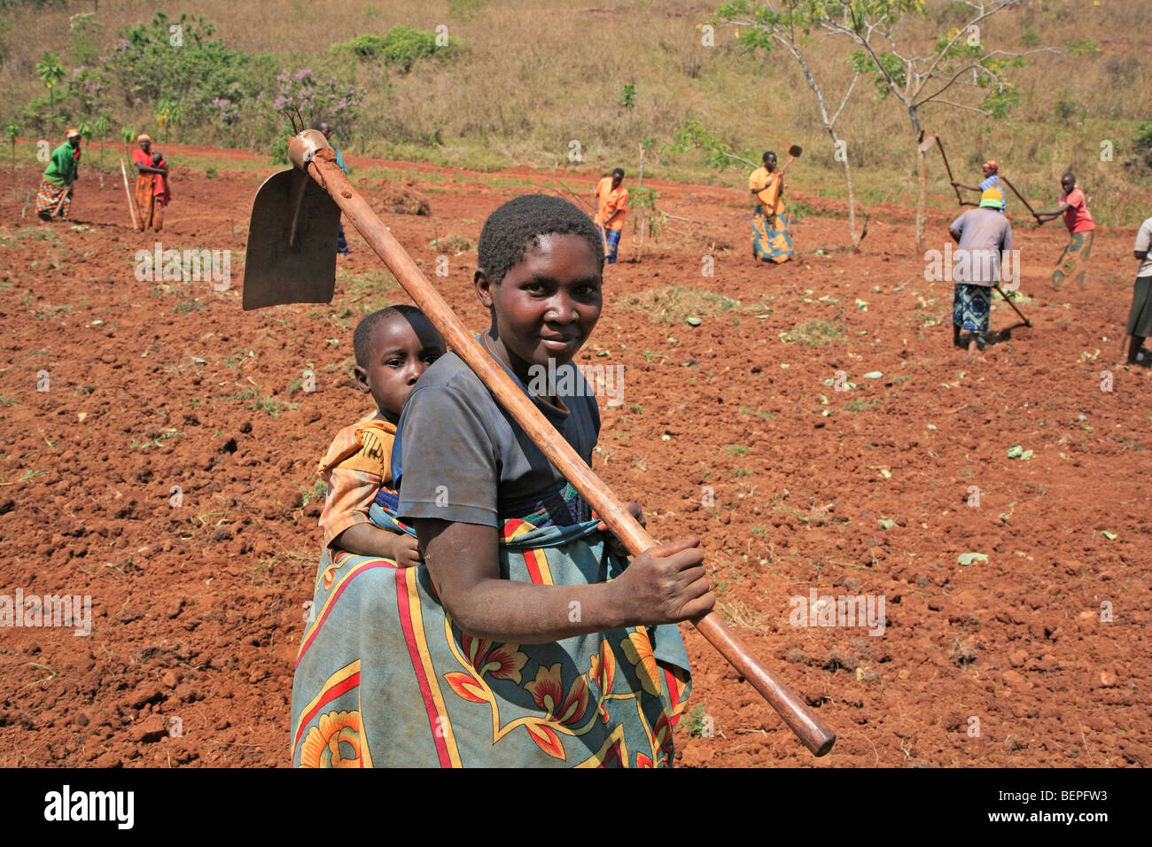 BURUNDI Woman carrying a hoe, Gitera. PHOTOGRAPH by Sean Sprague 2009 ...