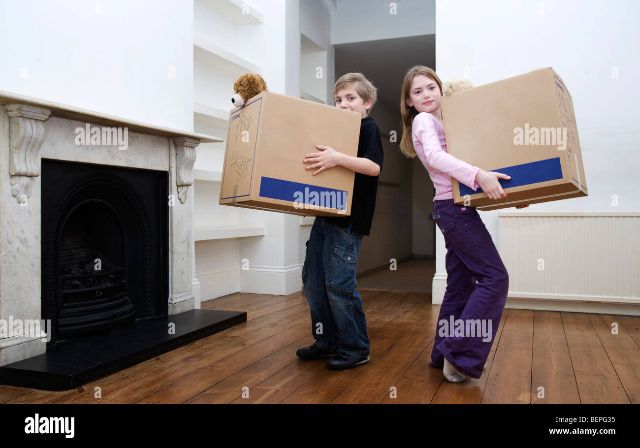 Two children holding boxes Stock Photo - Alamy