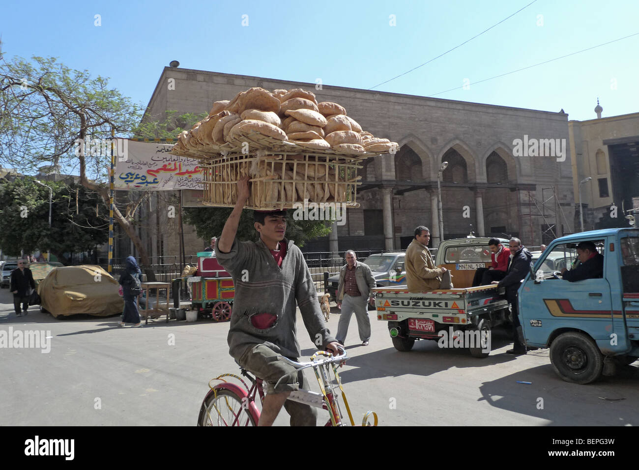 EGYPT Khan al-Khalili, Islamic old Cairo. Man carrying bread on a ...