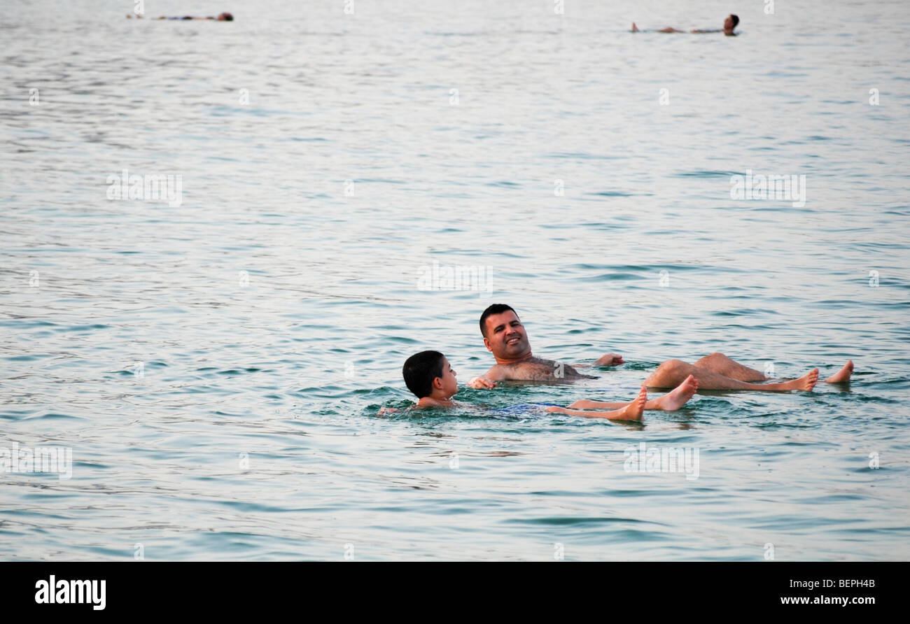 Israel, Dead Sea People float in the heavy water of the Dead Sea Stock ...
