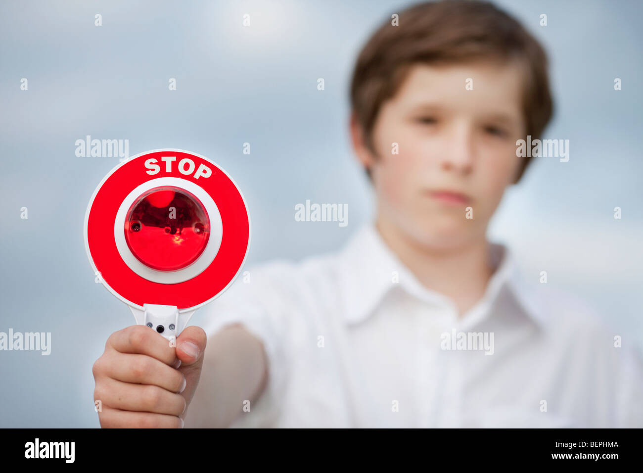 young boy holding up stop sign Stock Photo - Alamy
