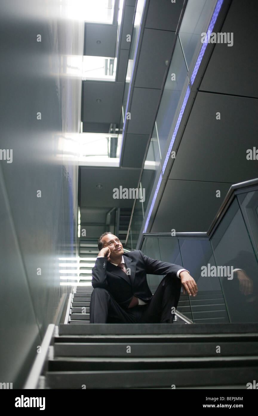 man sitting on stair steps Stock Photo - Alamy
