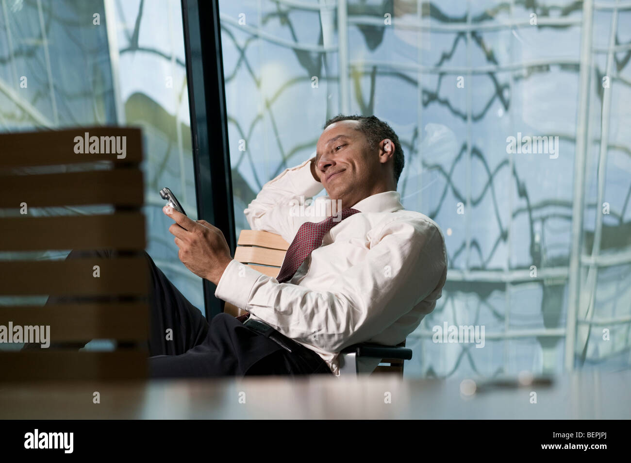 man leaning back in chair smiling Stock Photo - Alamy