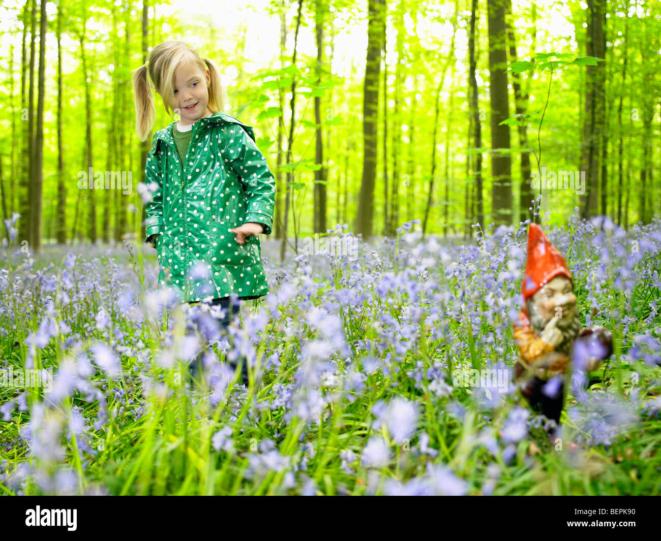 Girl looking at a garden gnome Stock Photo - Alamy