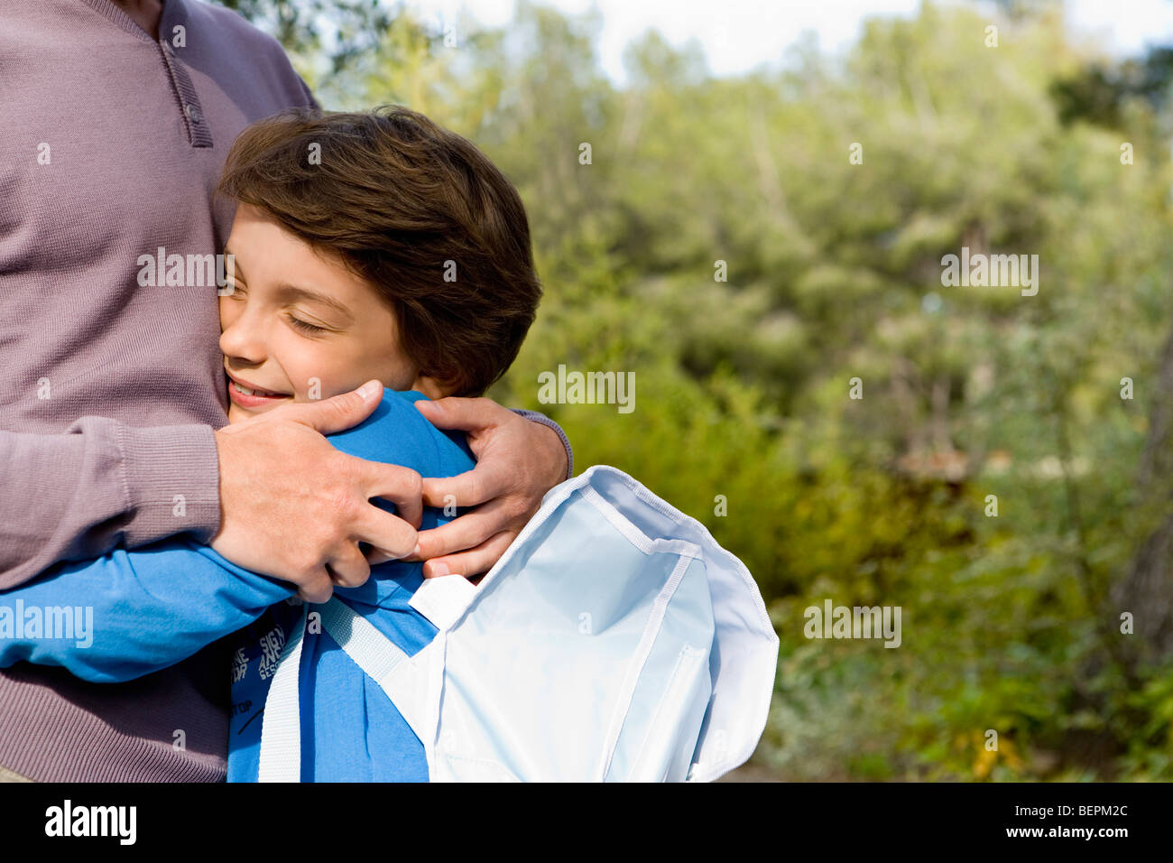 happy boy hugging dad back from school Stock Photo - Alamy