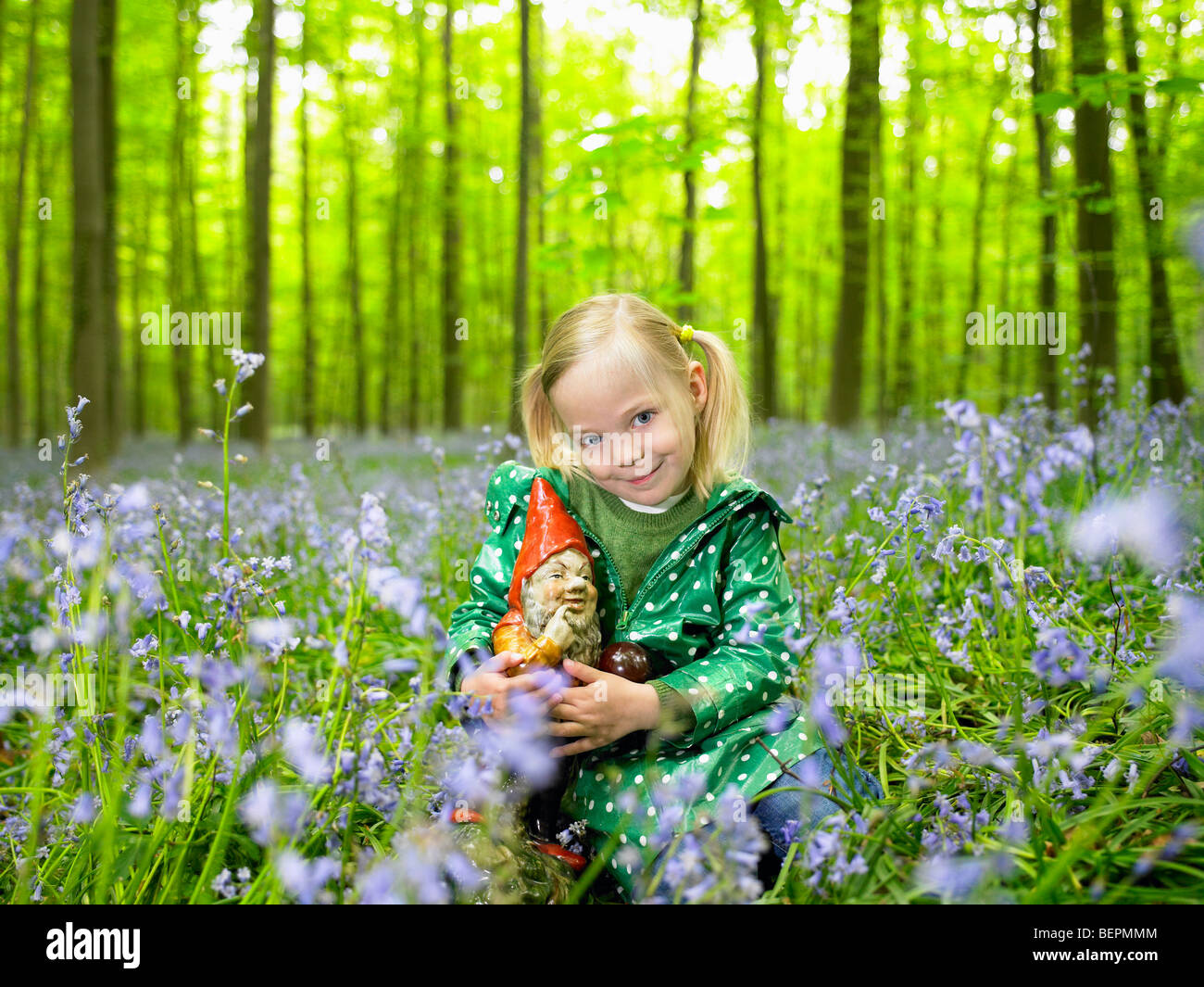 Girl with a garden gnome, in the woods Stock Photo - Alamy