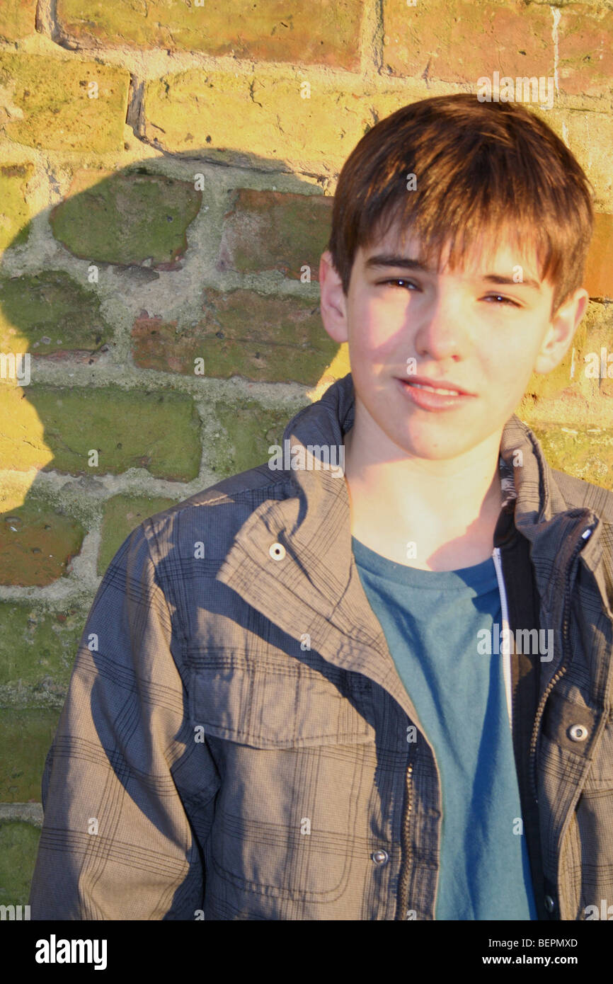 Teenager leaning against a brick wall hi-res stock photography and ...
