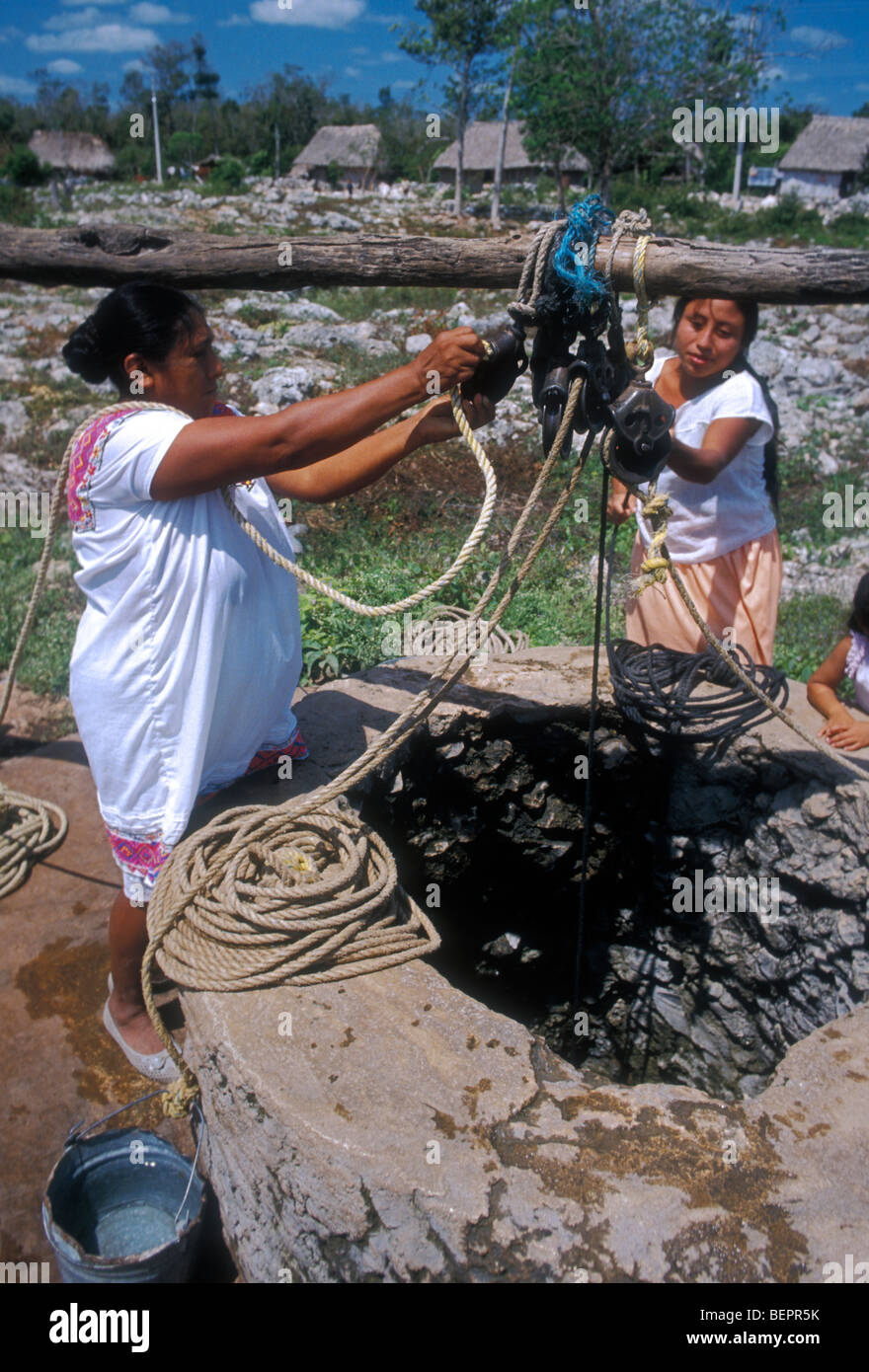 Mexican people, Mayan people, drawing water from well in the village of ...