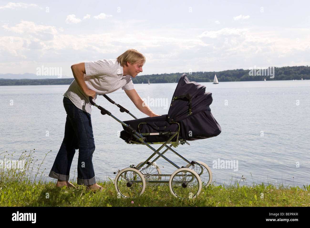 dad pushing baby in pram Stock Photo - Alamy