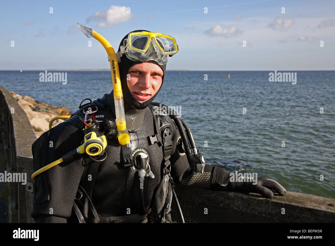 Scuba diver standing on the jetty in his gear ready to dive Stock Photo ...
