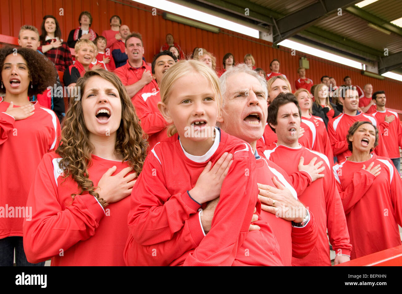 Fans singing anthem at football match Stock Photo - Alamy