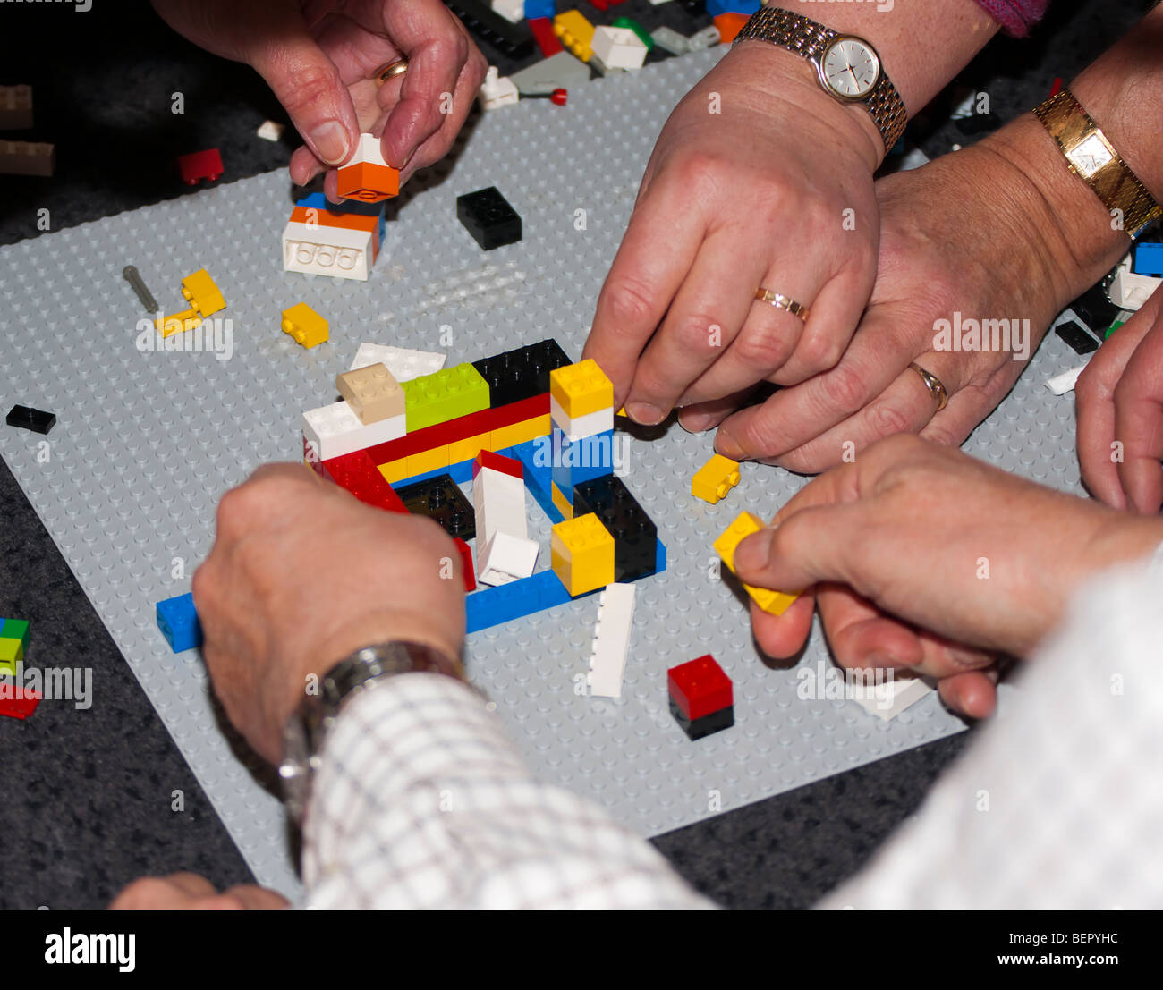 Teamwork building LEGO Stock Photo - Alamy