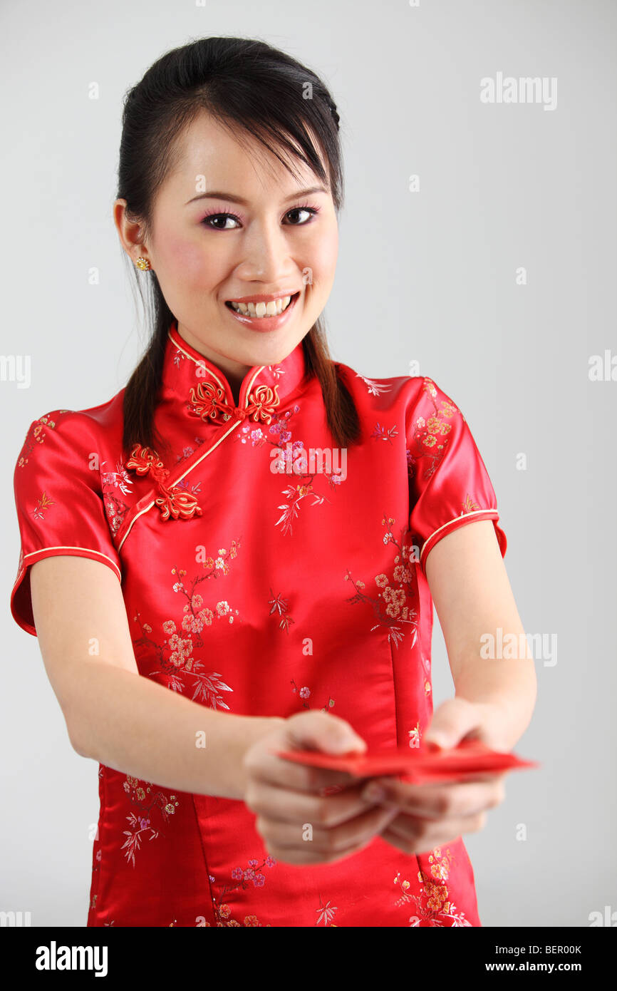 Young woman giving angpao packet Stock Photo - Alamy