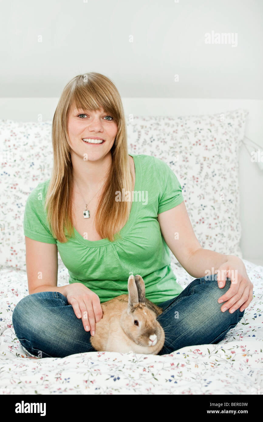 Young woman with pet rabbit Stock Photo - Alamy