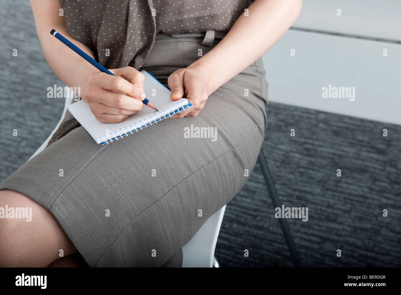 woman writing on notepad Stock Photo - Alamy