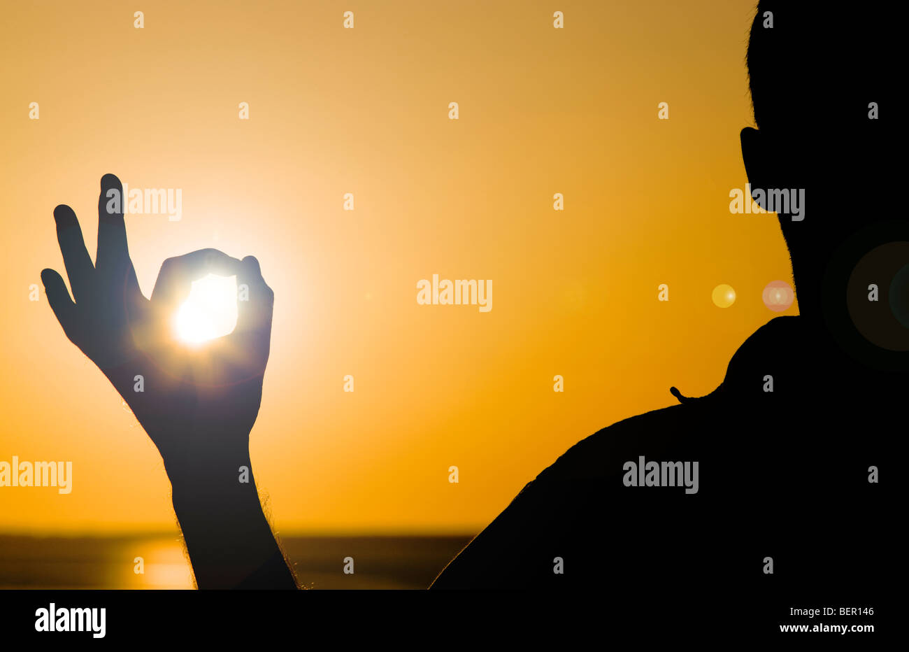 Person holding the sun Stock Photo - Alamy