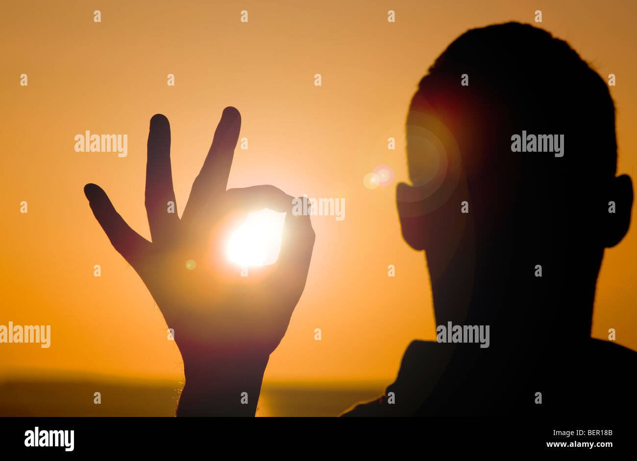 Person holding the sun Stock Photo - Alamy