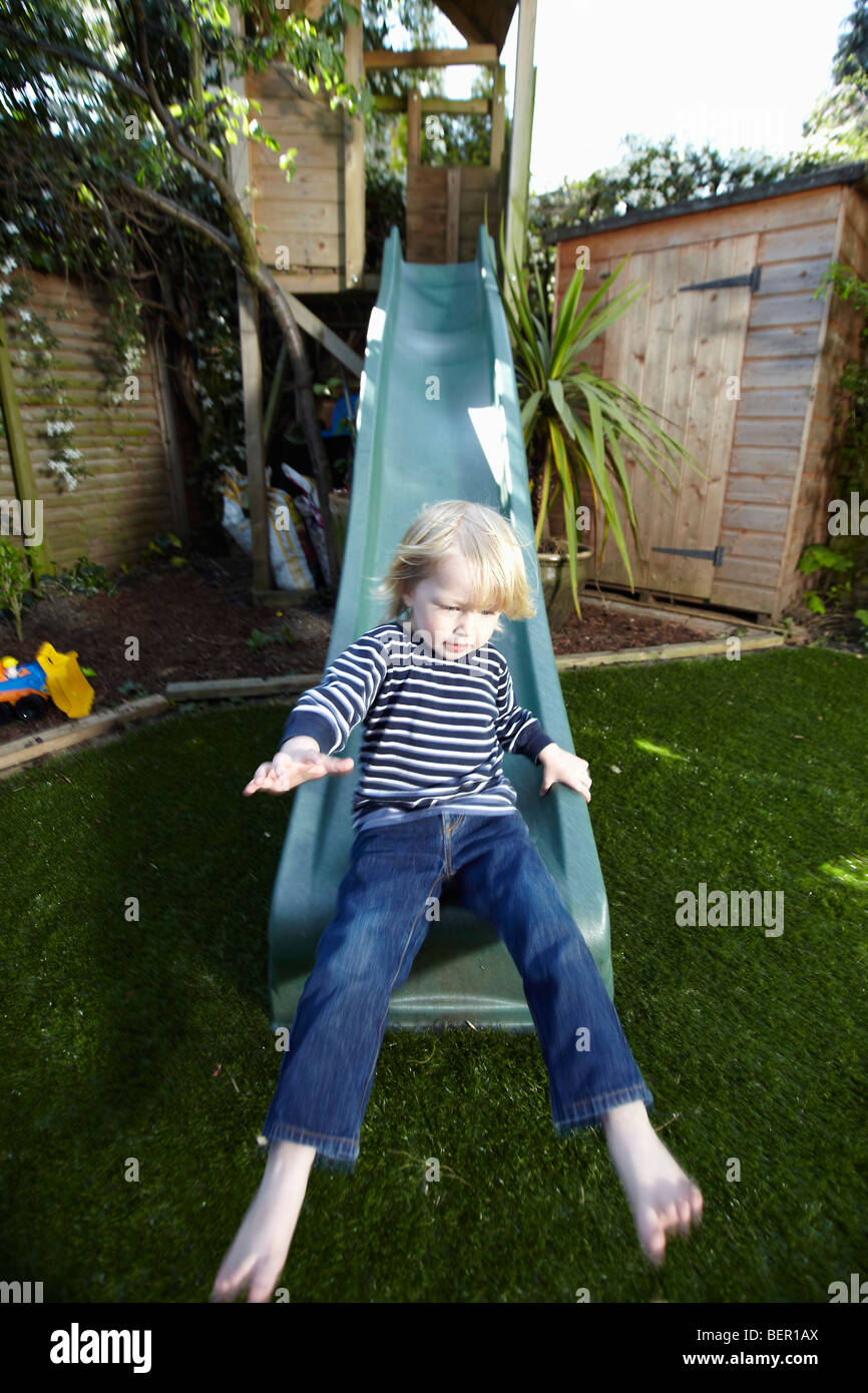 Young boy on a slide Stock Photo - Alamy