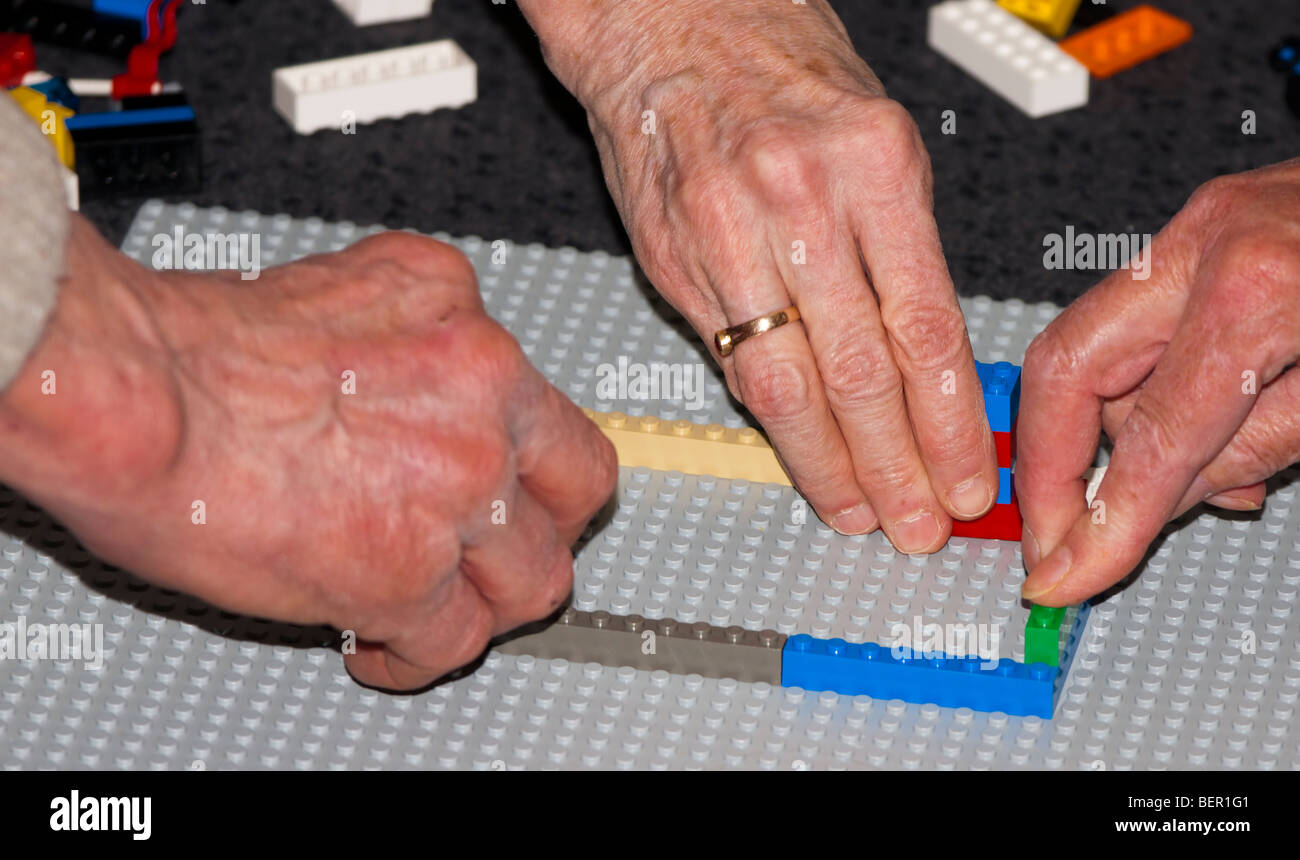 Teamwork building LEGO Stock Photo - Alamy