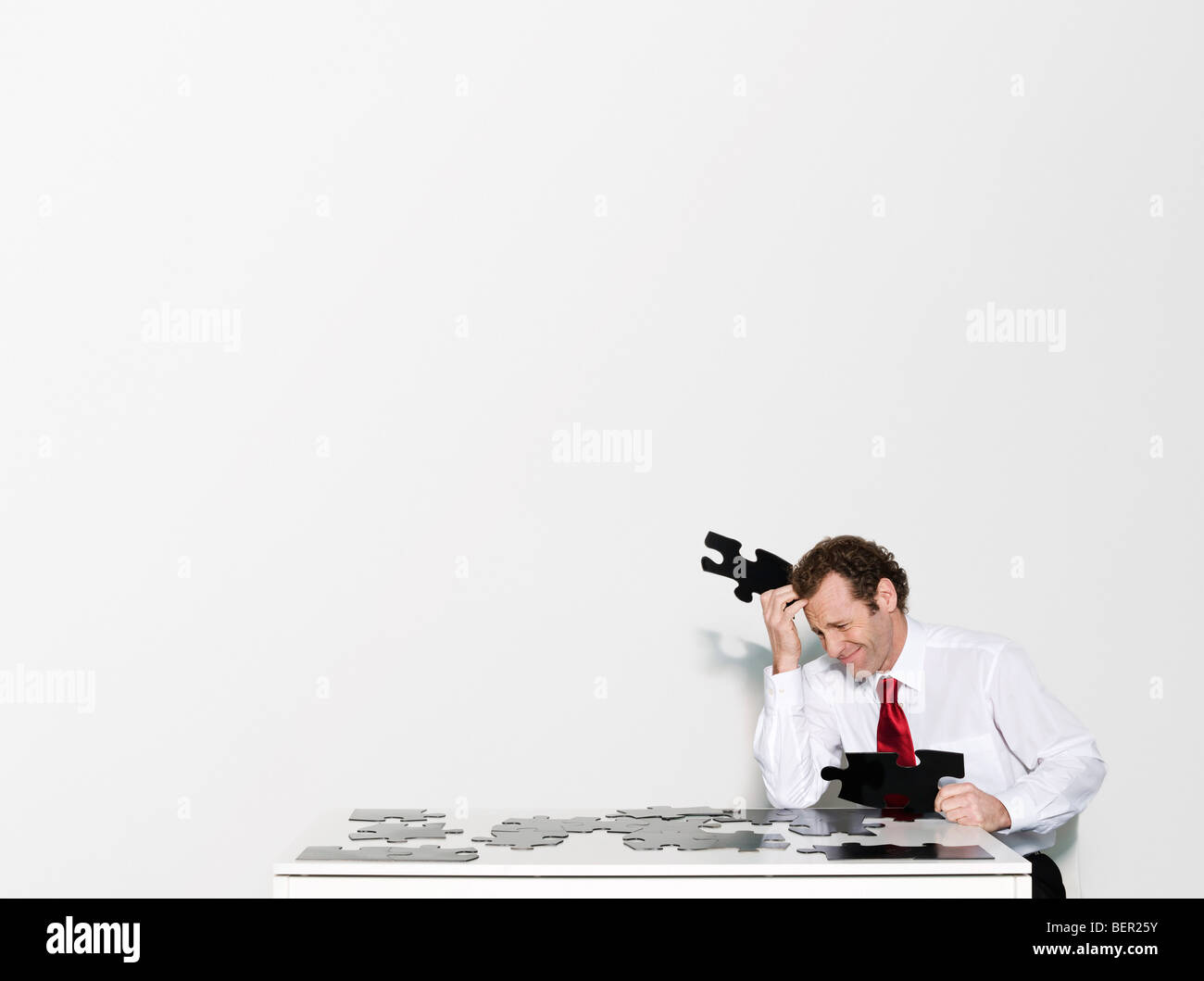 Hands doing a jigsaw puzzle hi-res stock photography and images - Alamy