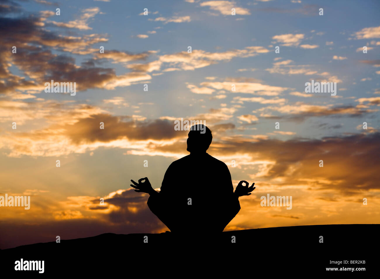 Yoga meditation at sunset Stock Photo - Alamy