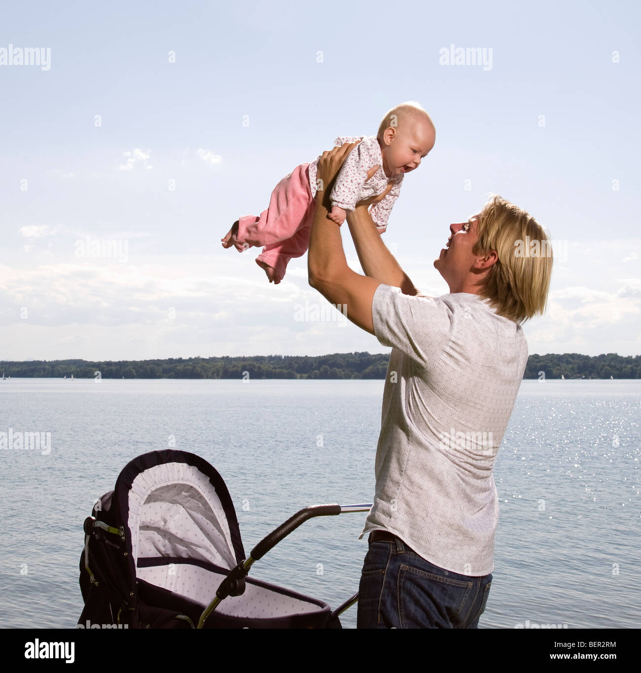 dad lifting baby from pram Stock Photo - Alamy